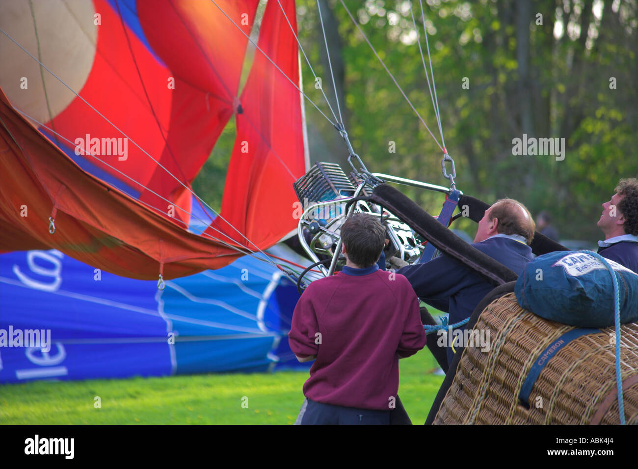 Ground crew steadying base of a hot air balloon during rotation Stock ...