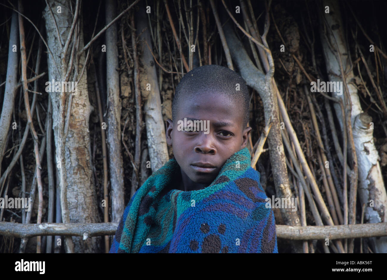 A Basotho herd boy stands by a traditional hut in a highland village ...