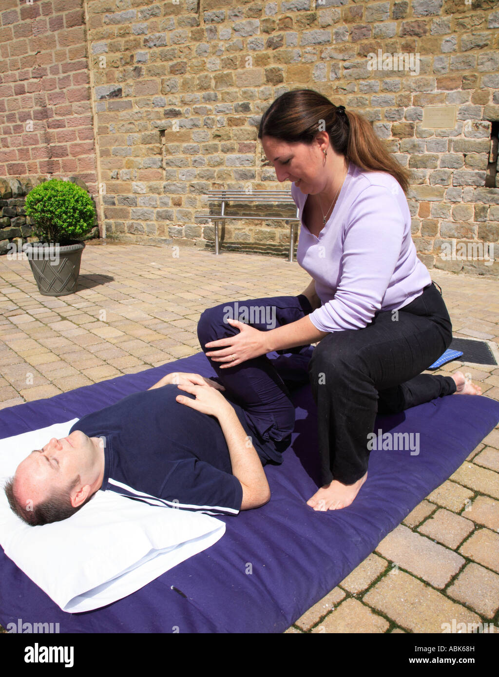 Leg stretching as part of a Thai body massage Stock Photo - Alamy