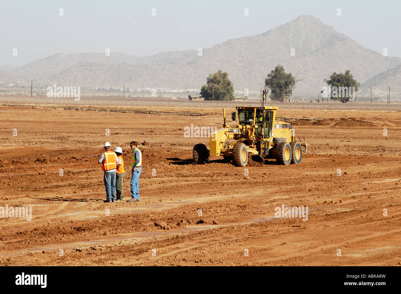 grading equipment at work preparing a construction site for development ...