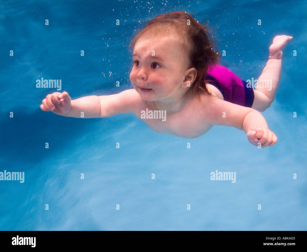 baby swimming under water blue background Stock Photo - Alamy