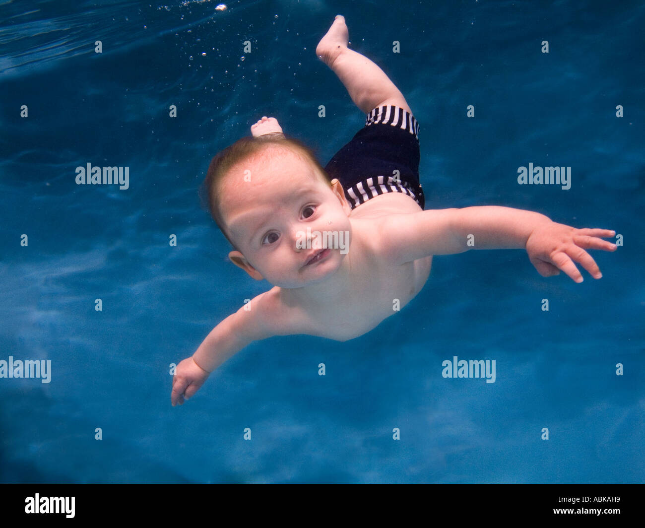 baby swimming under water blue background Stock Photo - Alamy