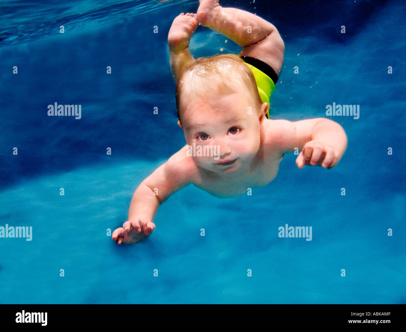 baby swimming underwater blue background Stock Photo - Alamy