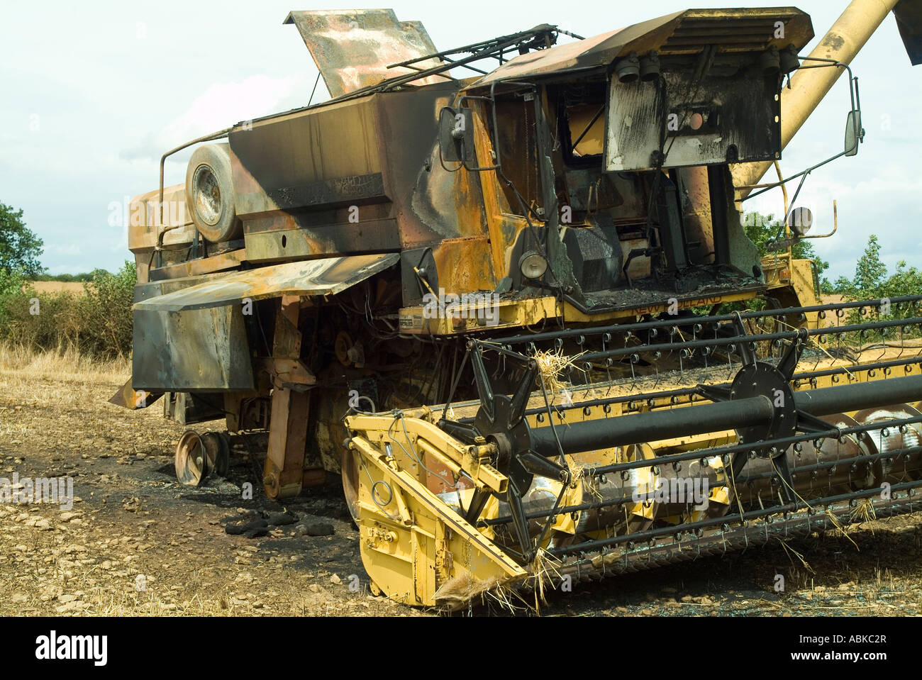 new holland combine harvester destroyed by fire Stock Photo - Alamy