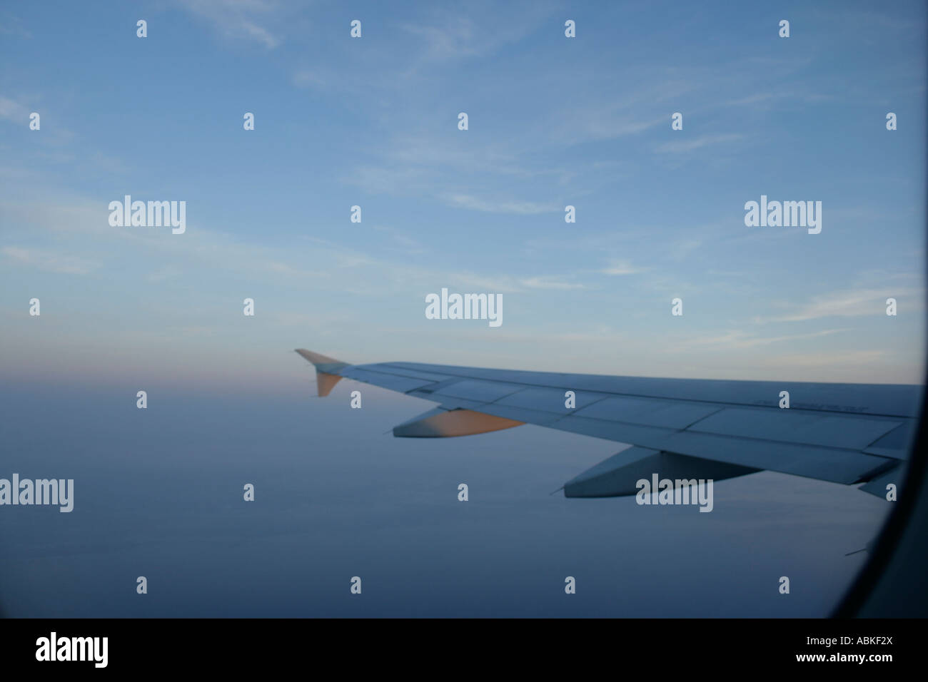 Airplane wing through window Stock Photo - Alamy