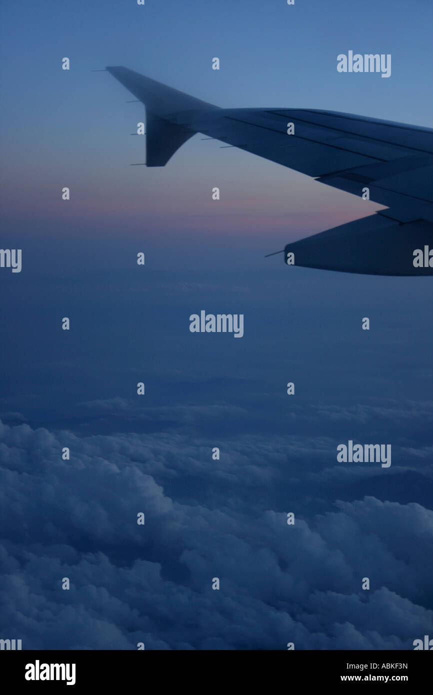 Plane wing in sunset Stock Photo - Alamy