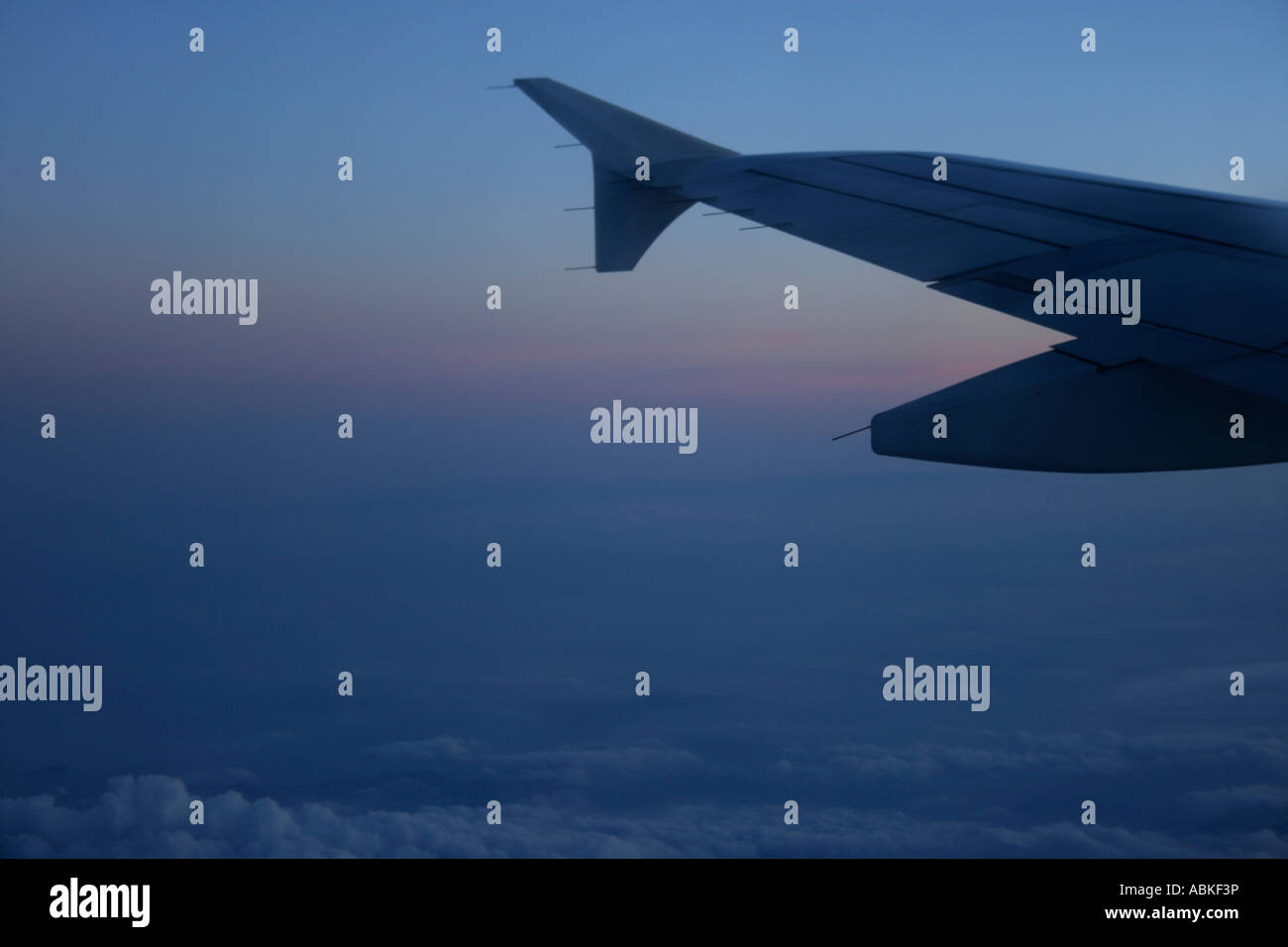 Plane wing in sunset Stock Photo - Alamy