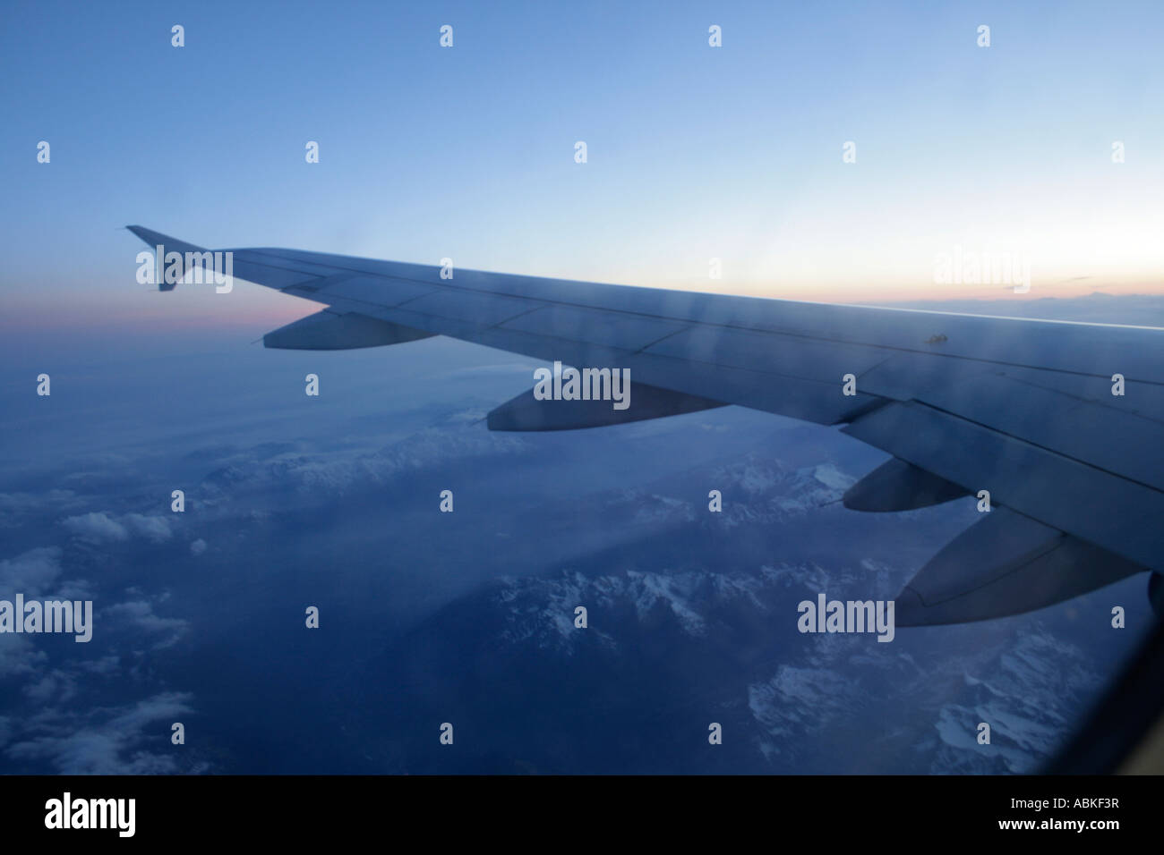 Plane wing in sunset Stock Photo - Alamy