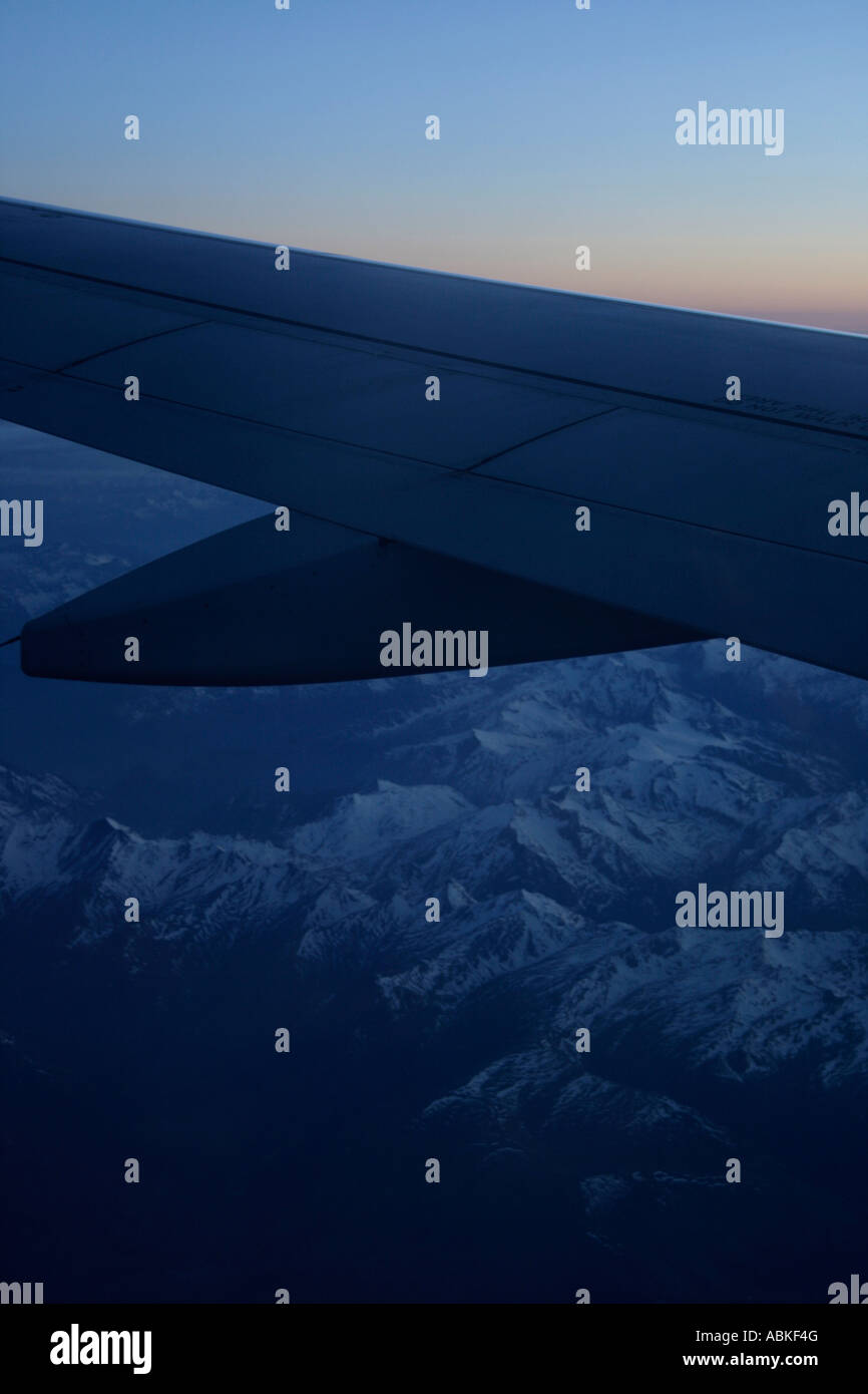 Plane wing in sunset Stock Photo - Alamy