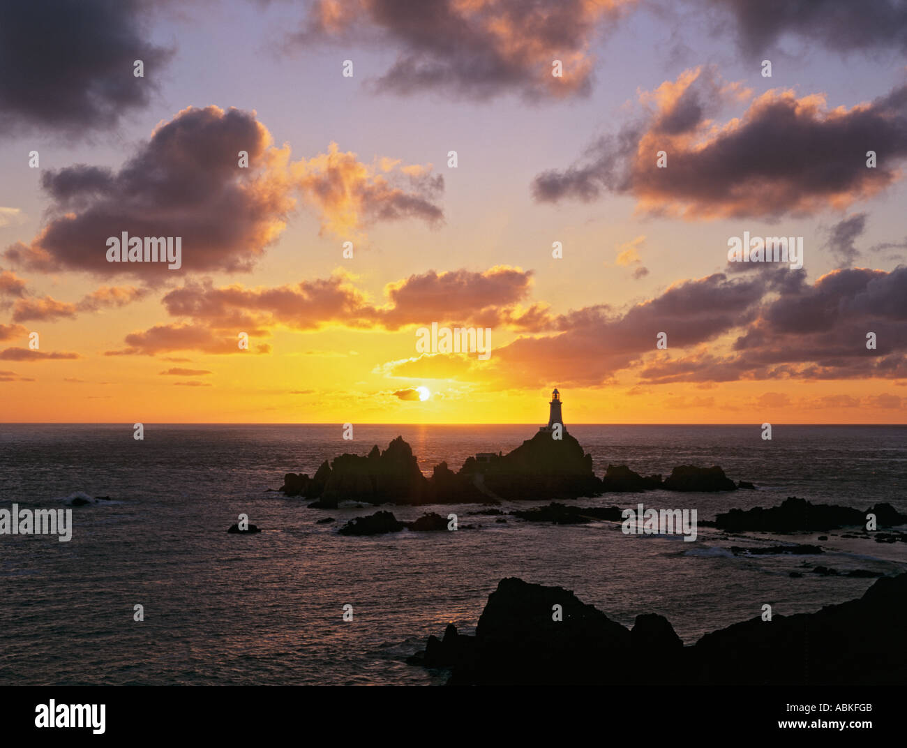 CORBIERE LIGHTHOUSE in silhouette at sunset. Corbiere Point Jersey ...