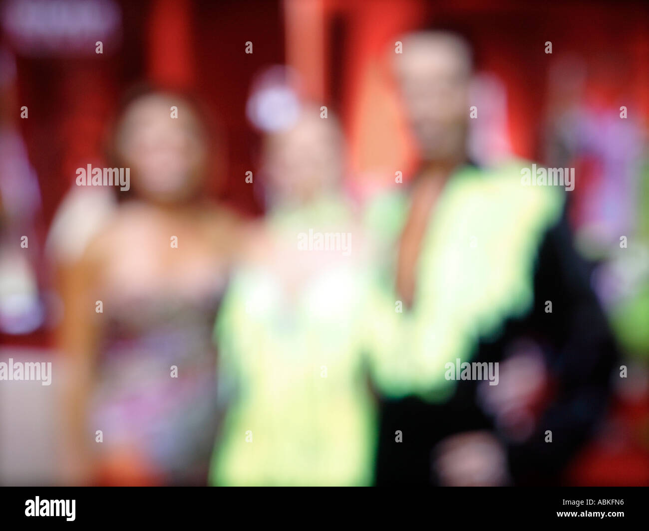 Three dance performers against red background blur effect Stock Photo ...