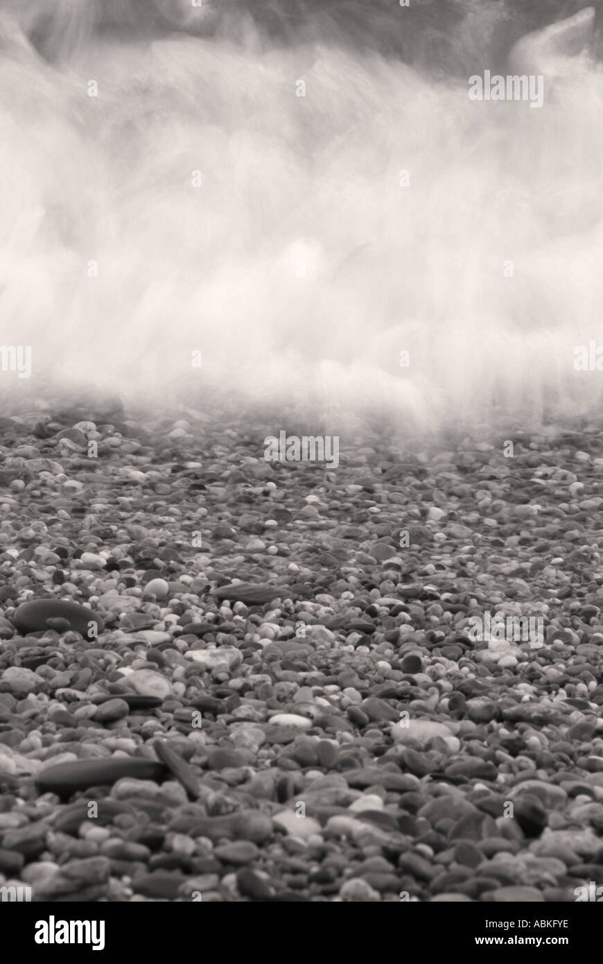 Wave crashing on pebbles Stock Photo - Alamy