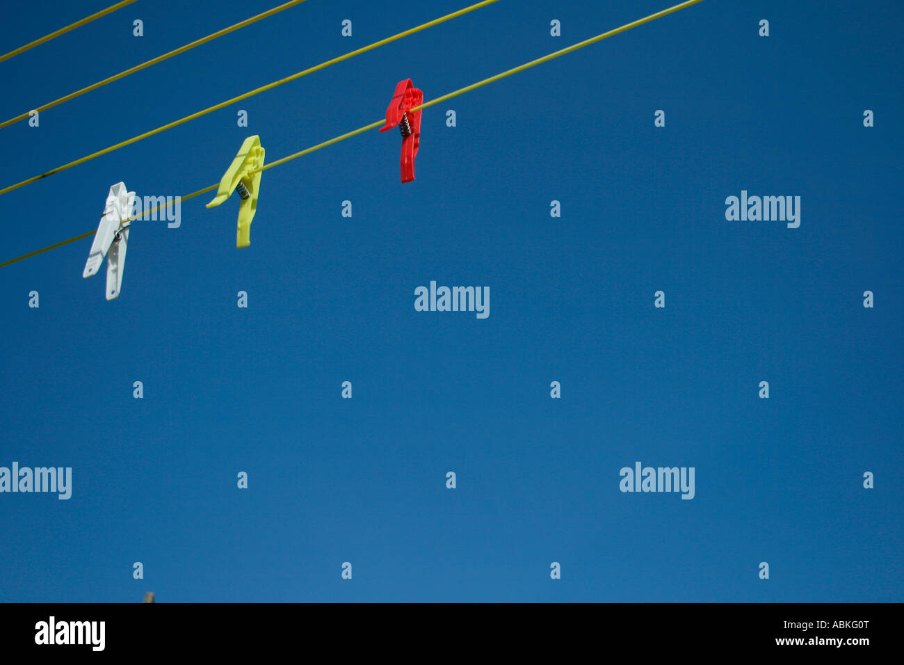 Coloured clothes pegs hanging on washing line Stock Photo - Alamy