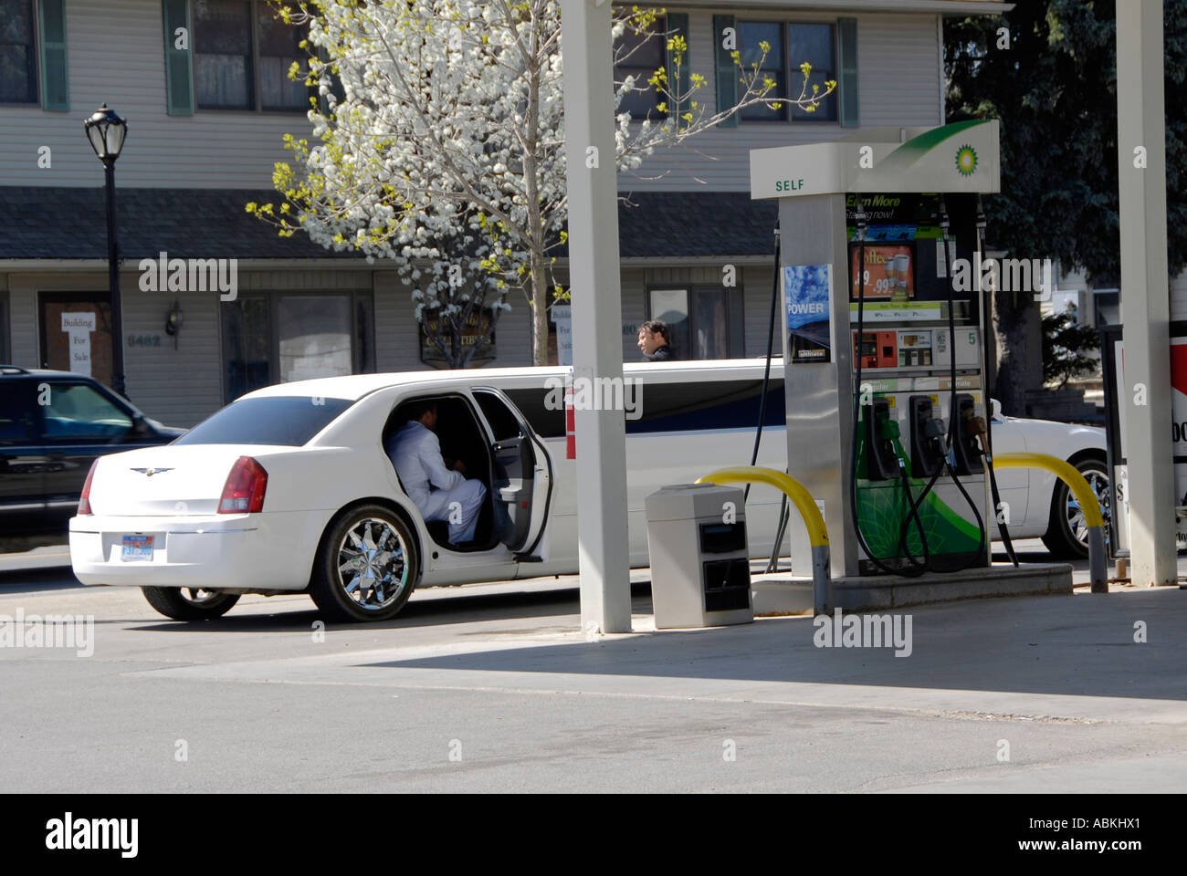 White limousine stops at a gasoline station to fill tank with gas Stock ...