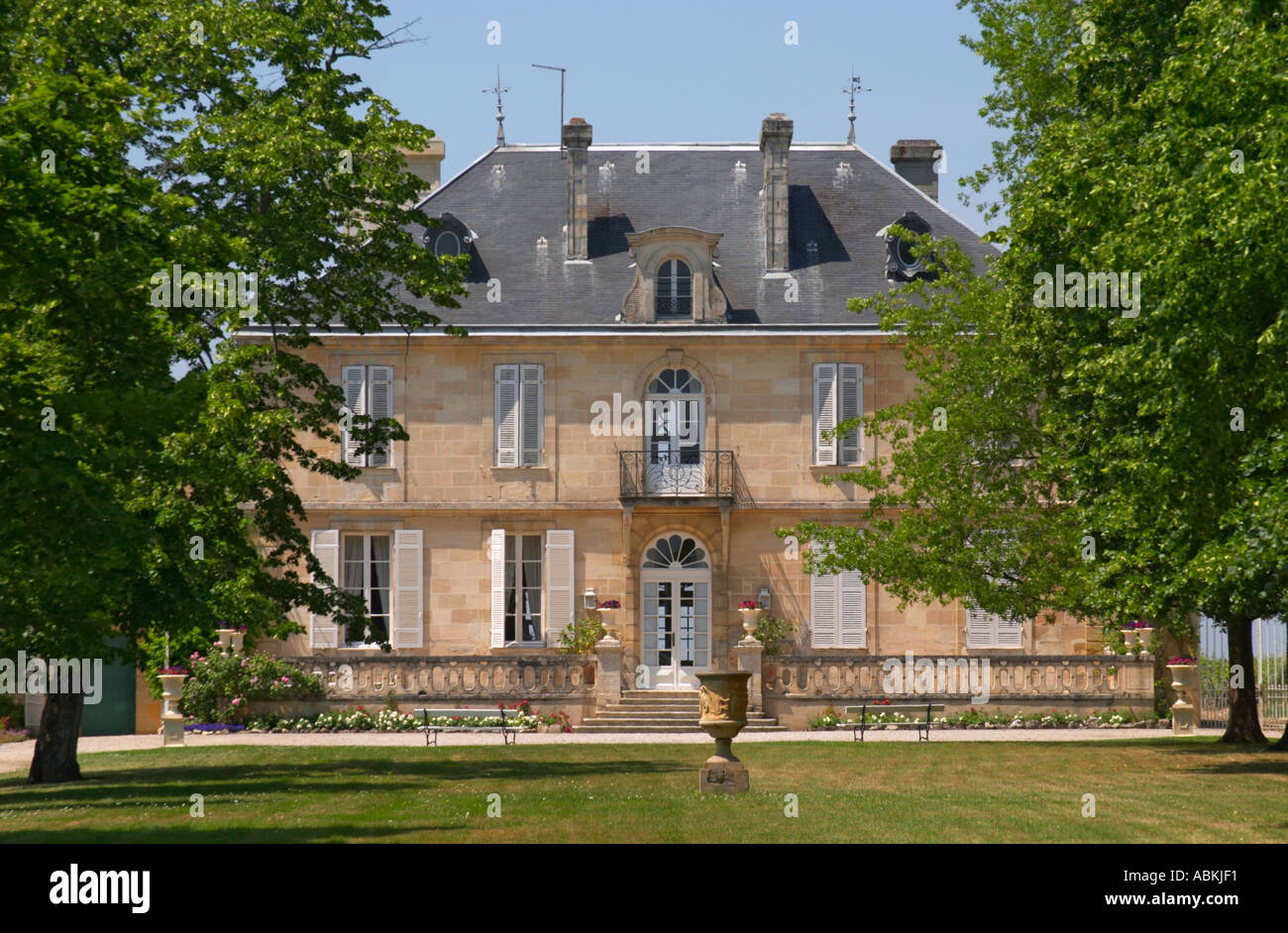 A view of the chateau building across the grass lawn in the garden ...