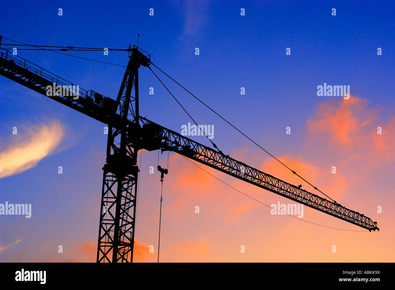 Construction crane at sunset Stock Photo - Alamy