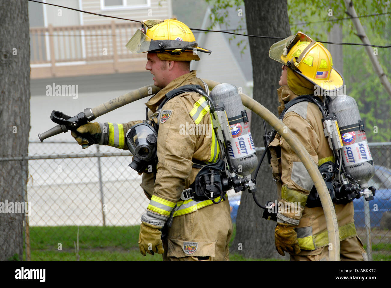 Firemen battle a residential home fire Stock Photo - Alamy
