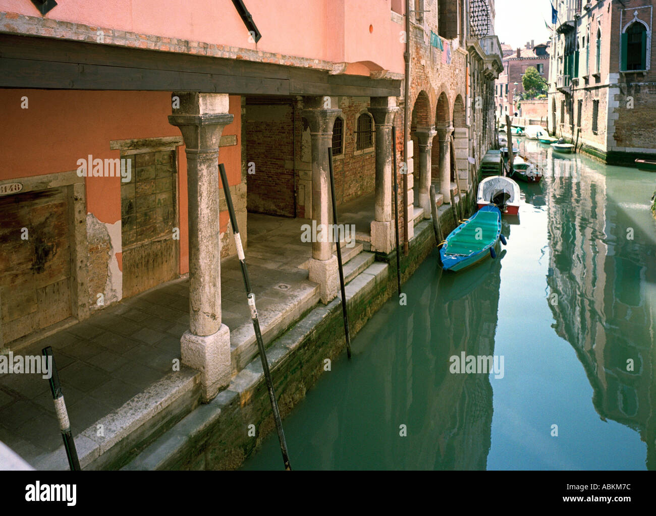 A typical scene in Venice with boats, bridges, ancient buildings and ...