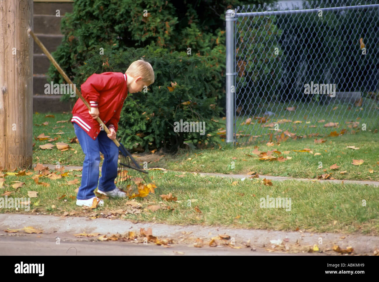 Child raking leaves hi-res stock photography and images - Alamy