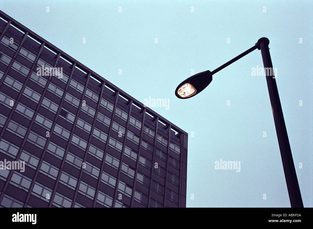 lit street lamp with office building in background Stock Photo - Alamy