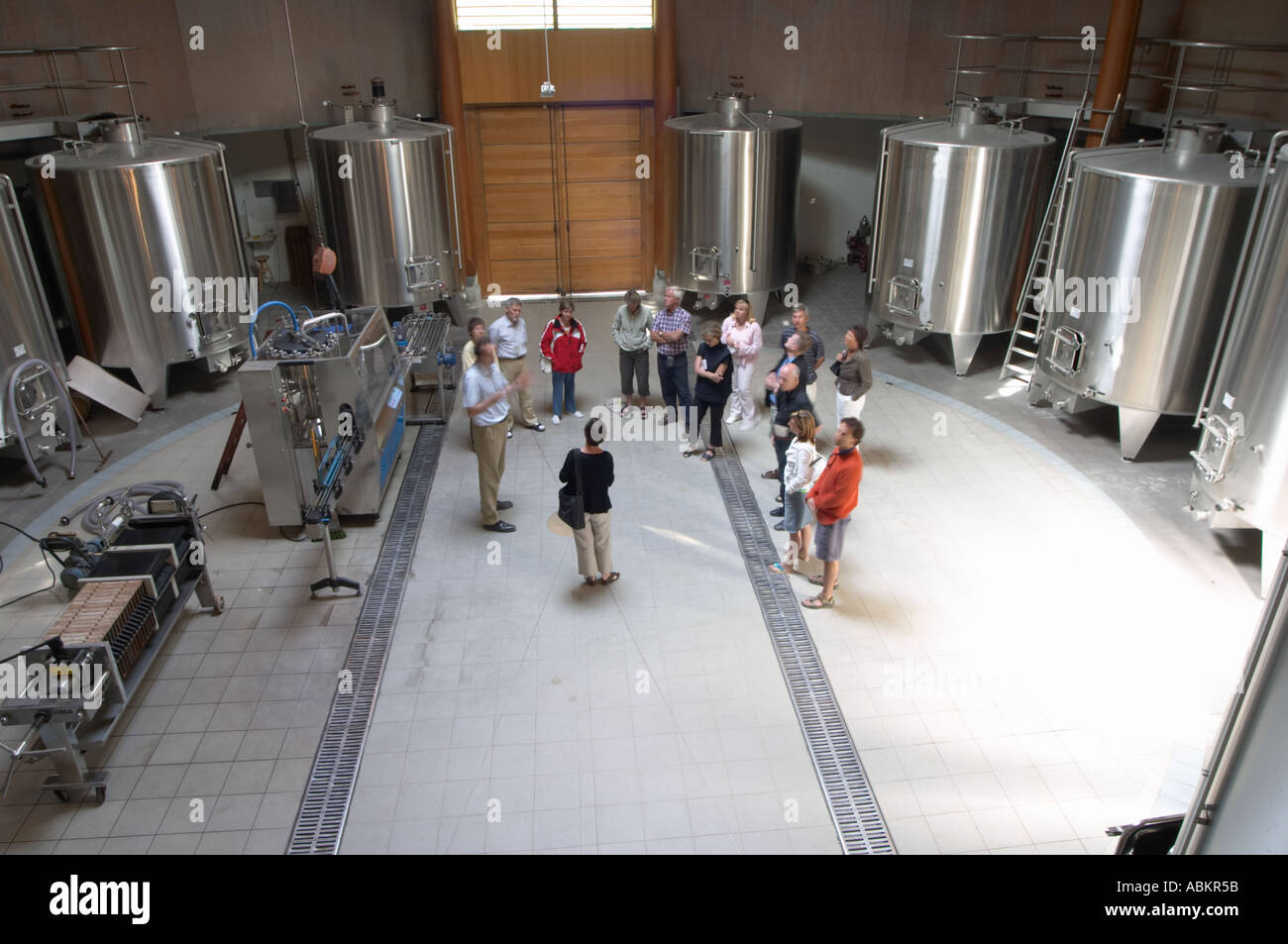 In the circular winery vat hall with stainless steel fermentation tanks ...