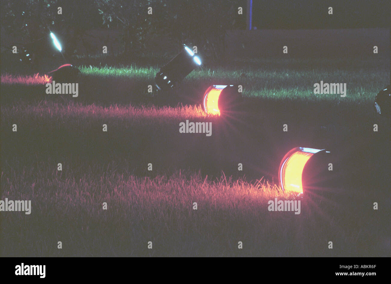 red coloured lights on lawn at night Stock Photo - Alamy