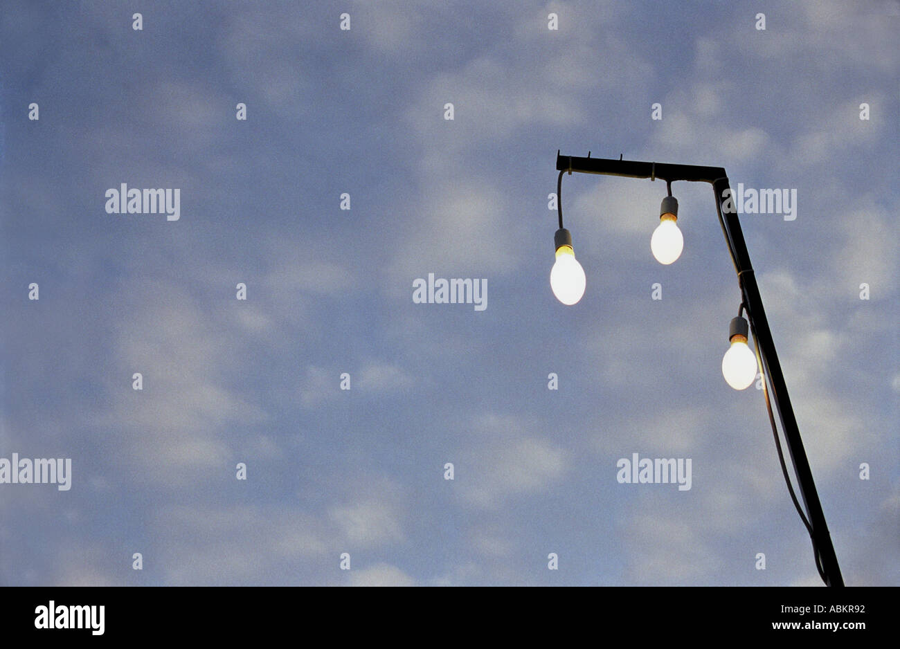 three bulb fitting against dark sky at night Stock Photo - Alamy