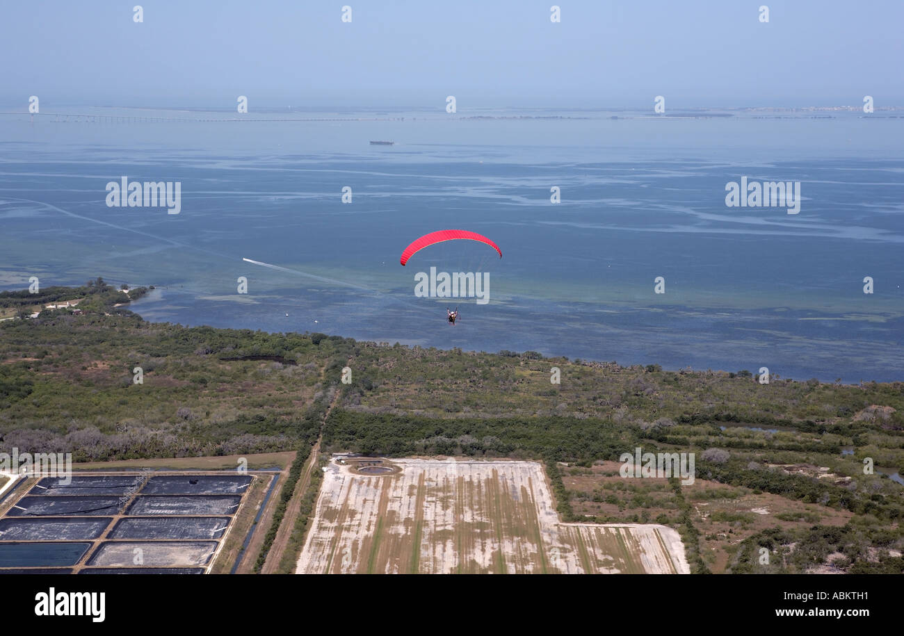 Aerial scenic photo of red paraglider paramotor flying near Tampa Bay ...