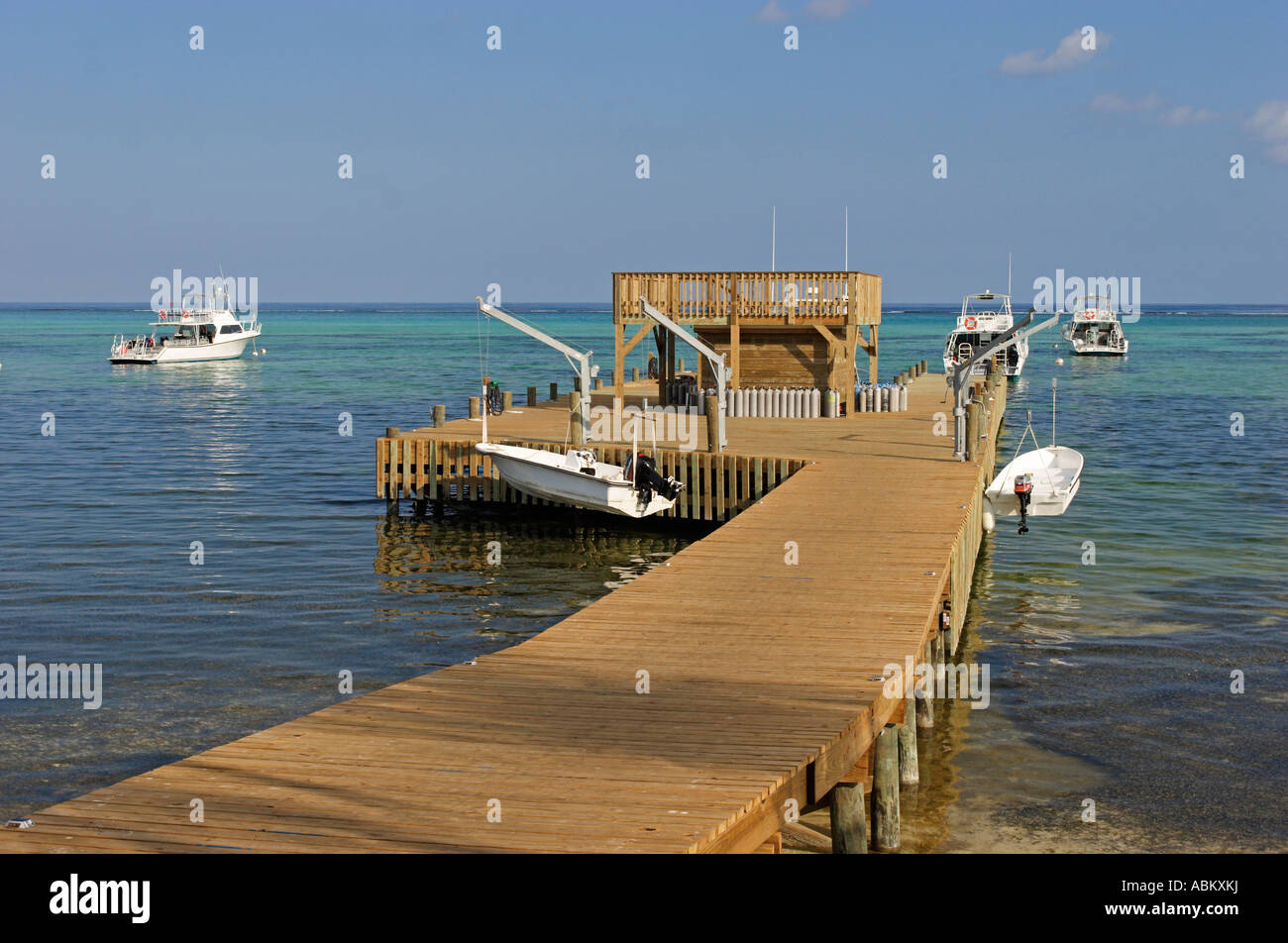 dive boats on a dock in the caribbean Stock Photo - Alamy