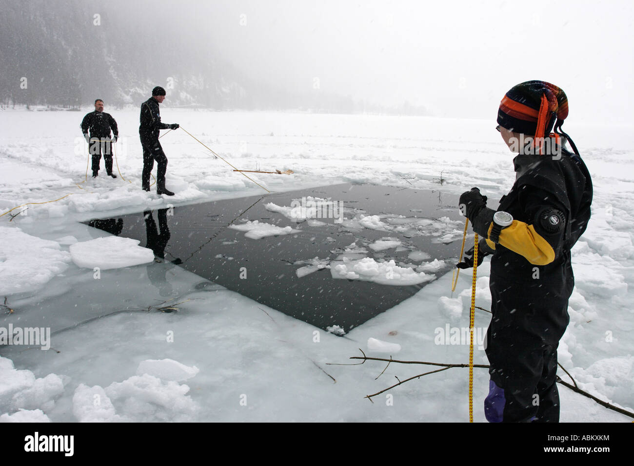 scuba diver with safety ropes on the surface of a frozen lake Stock ...