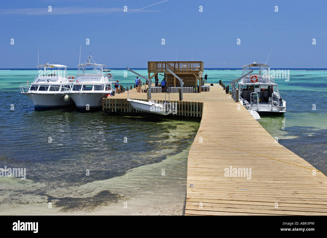 dive boats on a dock in the caribbean Stock Photo - Alamy
