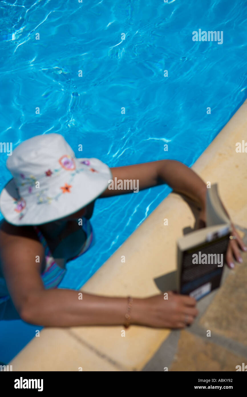 WOMAN READING IN A SWIMMING POOL Stock Photo - Alamy