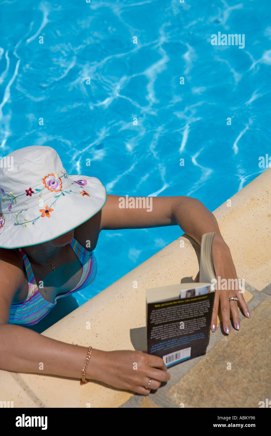 WOMAN READING IN A SWIMMING POOL Stock Photo - Alamy