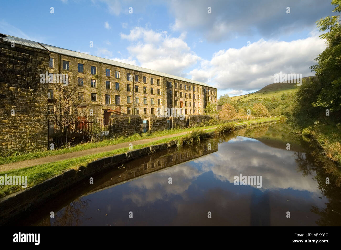 Old mill buildings by the side of the Huddersfield Narrow Canal ...