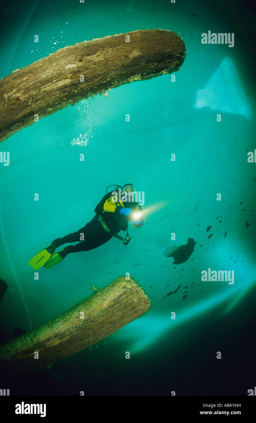 Ice diver diving into frozen lake hi-res stock photography and images ...