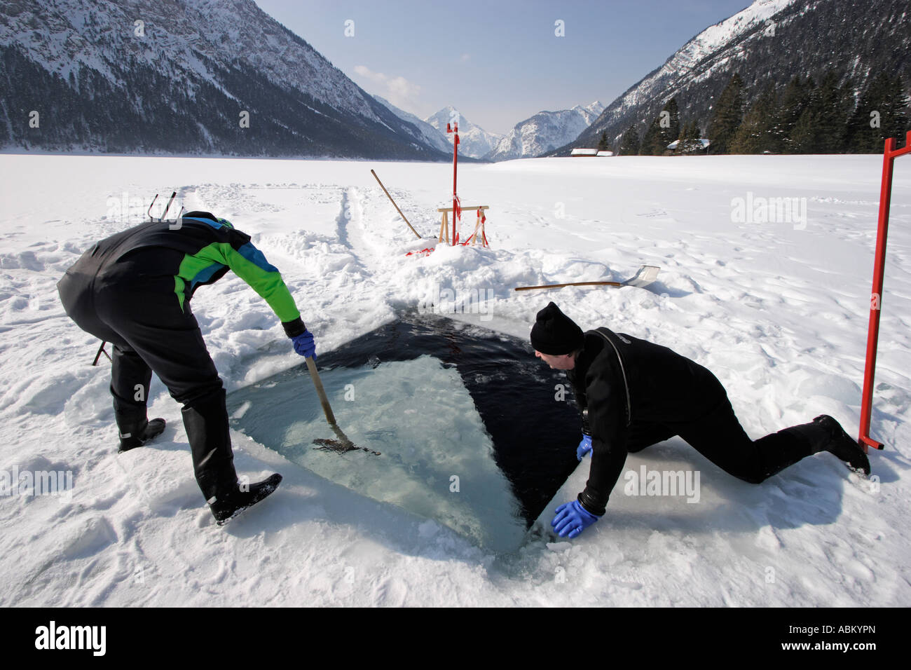 ice diver opening a hole Stock Photo - Alamy