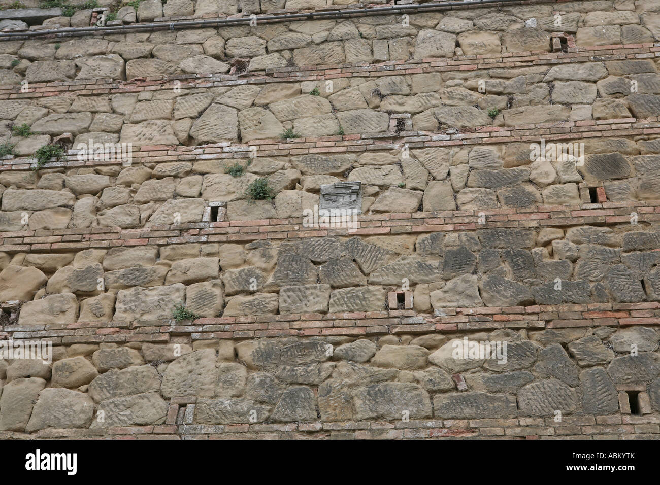 A traditional stone brick wall in a small village in Tuscany, Italy ...
