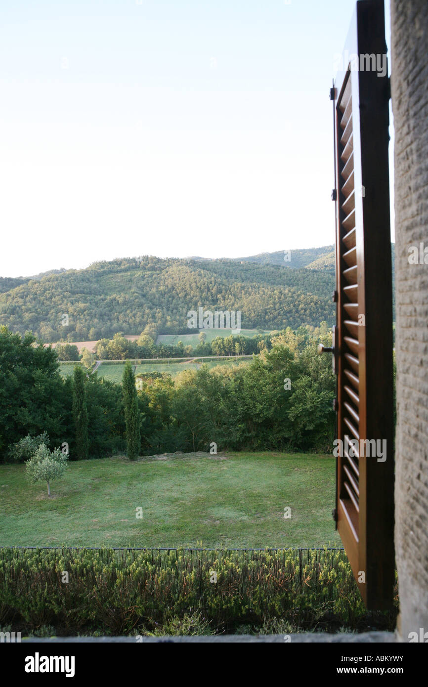 A view out of a window of a traditional Italian villa down a rural ...