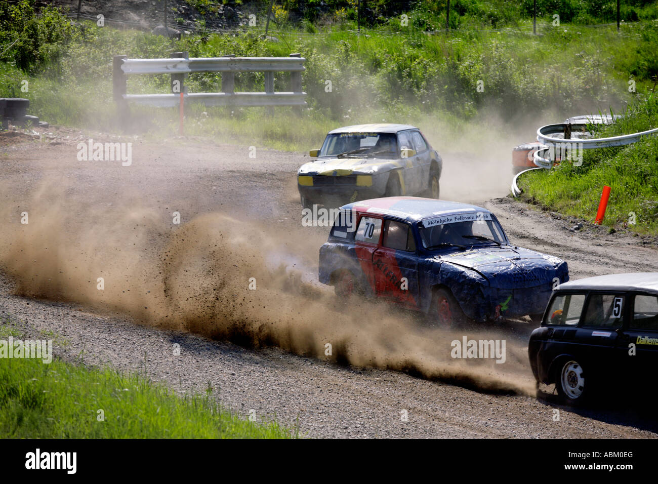 Throwing up dust and gravel Folkrace banger racing cars curve through ...