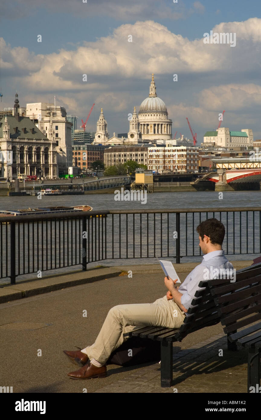 Man reading along the Thames in central London England UK Stock Photo ...