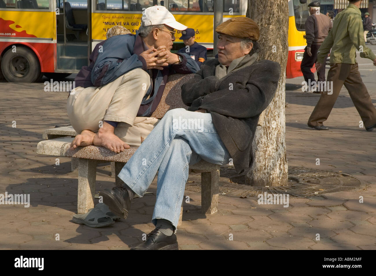 Two men resting on a bench near Hoan Kiem lake Hanoi Vietnam Stock ...