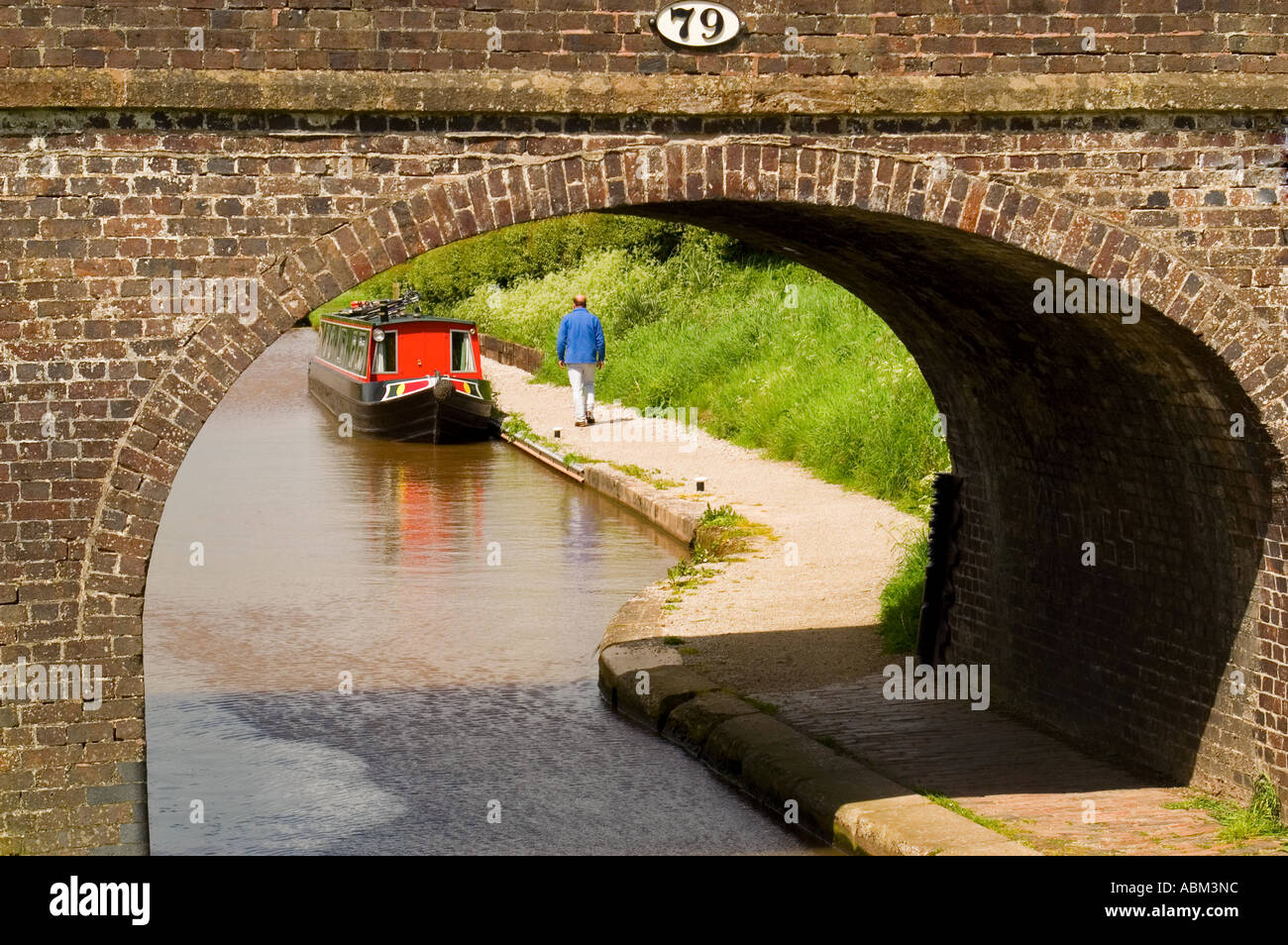 View under a canal bridge of a man returning to his canalboat Stock ...