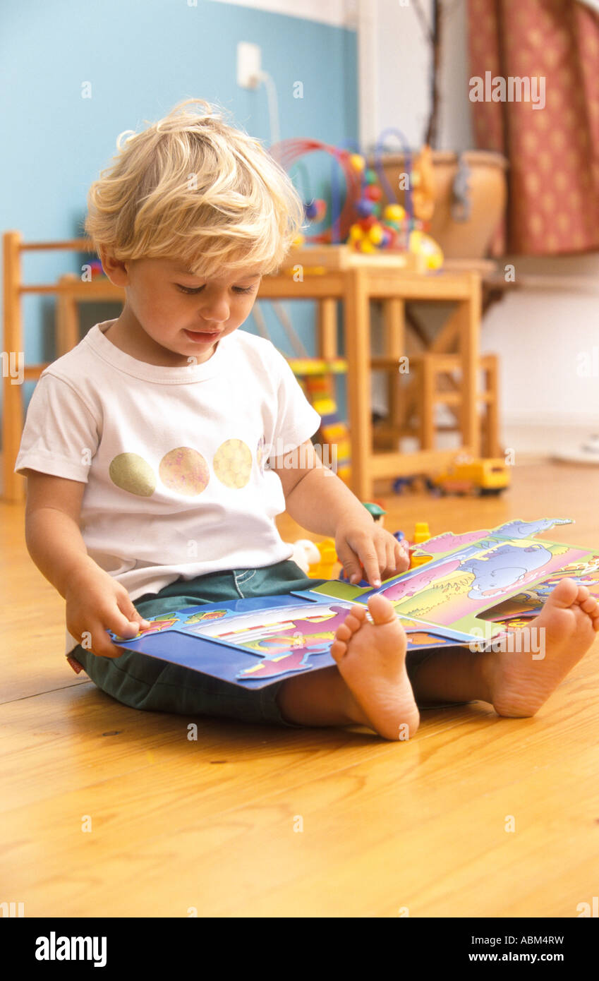 Little boy is reading a book Stock Photo - Alamy