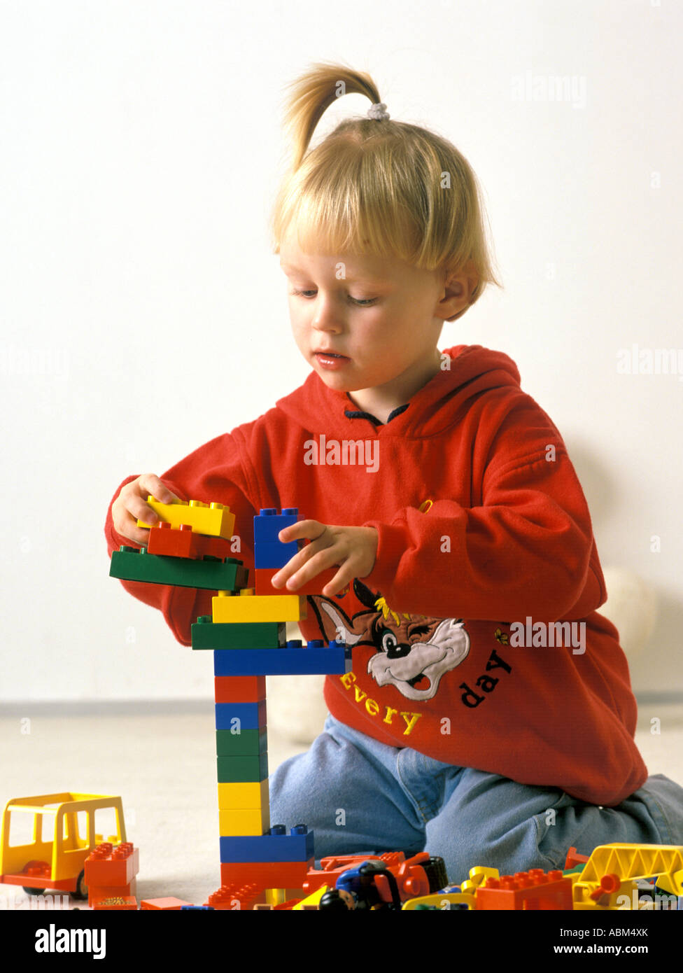 Little girl plays with Lego bricks Stock Photo - Alamy