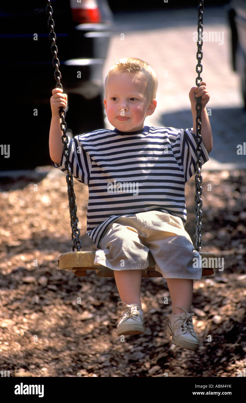Little boy on a swing Stock Photo - Alamy