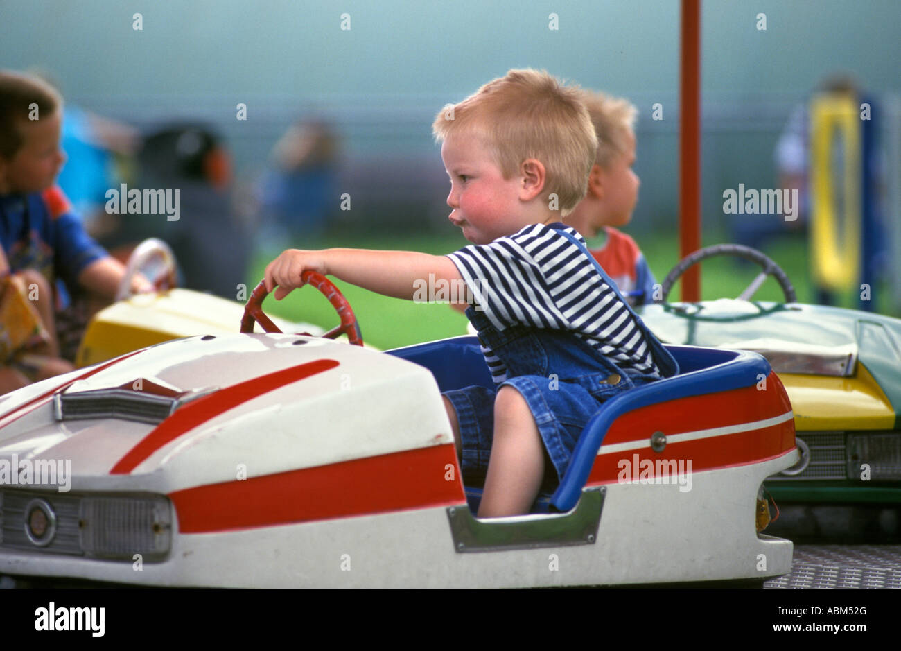 Little boy in a toy car Stock Photo - Alamy