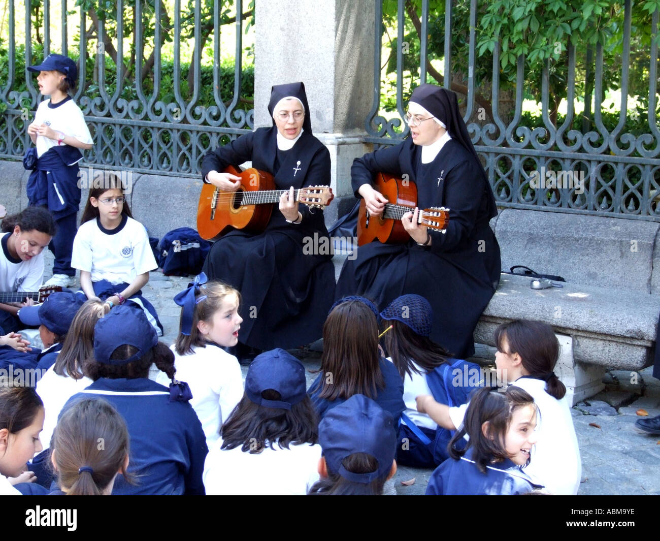 Singing nuns playing guitars entertain schoolgirls central Madrid Spain ...