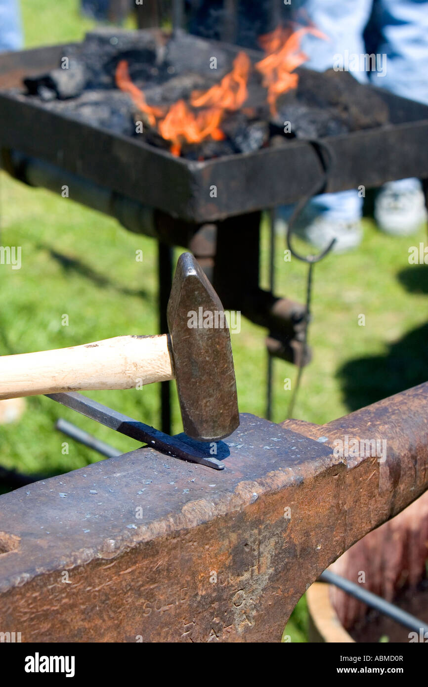 Blacksmith using a hammer to work with heated iron during a civil war ...