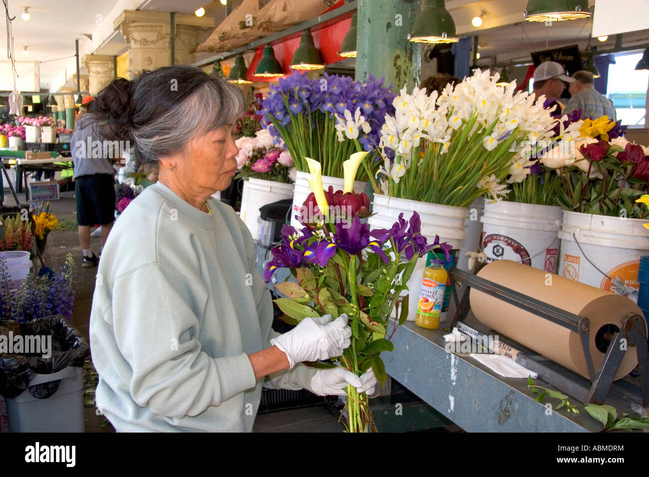 A florist arranging flowers at the Pike Place Market in Seattle ...
