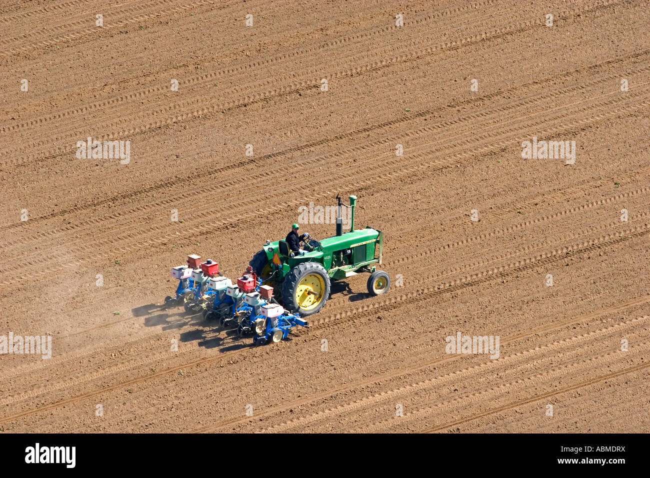 Aerial view of a farmer on a tractor planting seed in Canyon County ...